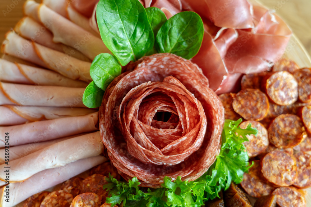 deli plate with salami rose and proscutto arranged with dried fig Stock ...
