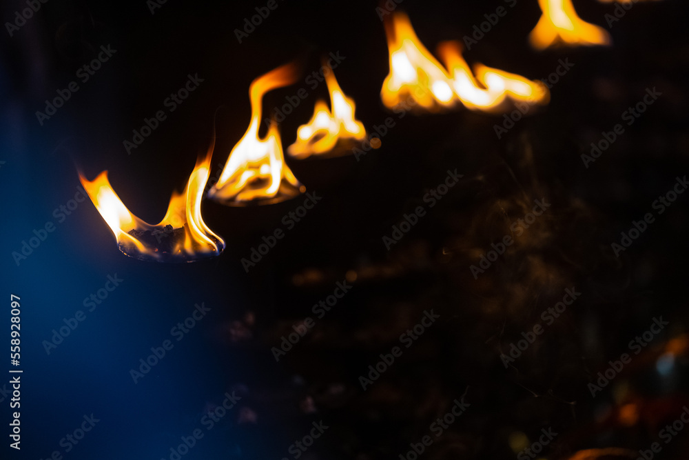 Fire flame at night with dark background during the ganga aarti rituals ...
