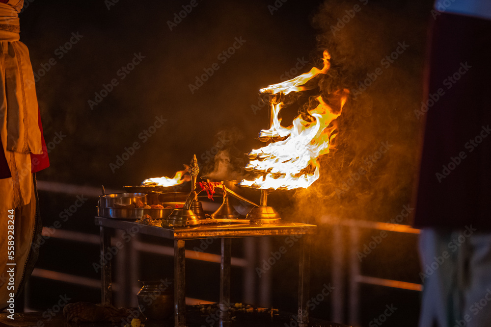 Poster Fire flame at night with dark background during the ganga aarti ...
