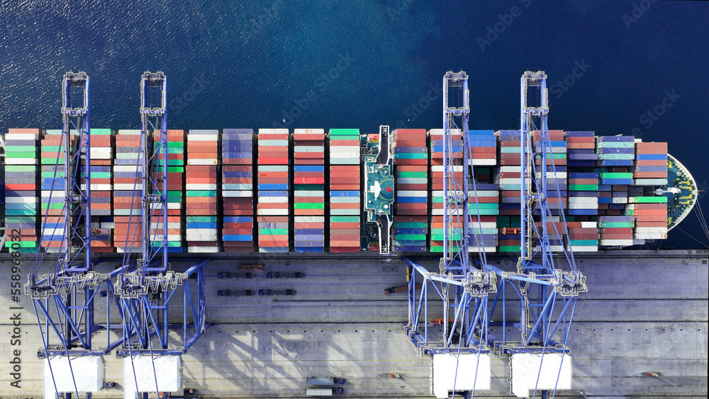Aerial top down photo of industrial cargo container ship being loaded ...