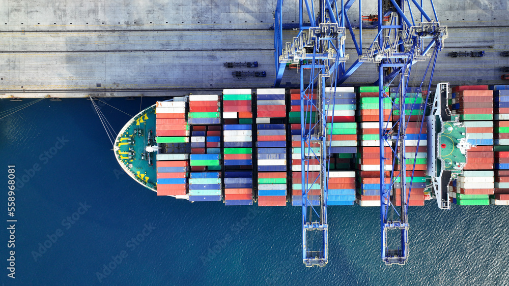 Aerial top down photo of industrial cargo container ship being loaded ...