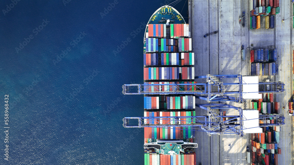 Aerial top down photo of industrial cargo container ship being loaded ...