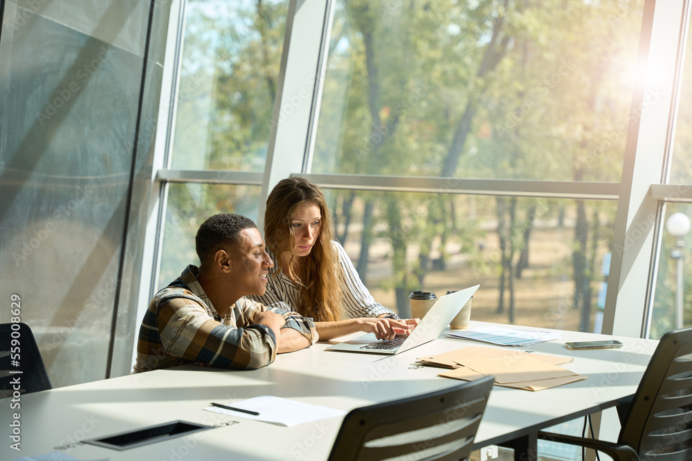 Happy two colleagues discussing new project in the office Stock Photo ...