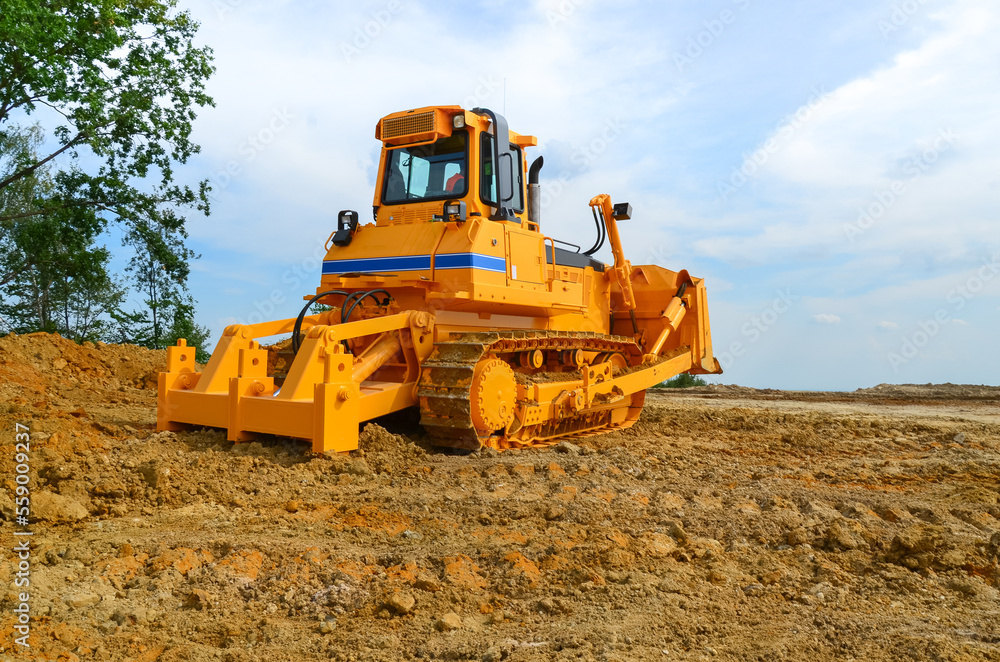 Crawler dozer working on construction site or quarry. Mining machinery ...