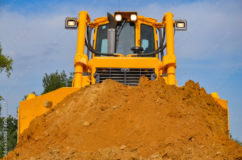 Crawler dozer working on construction site or quarry. Mining machinery ...