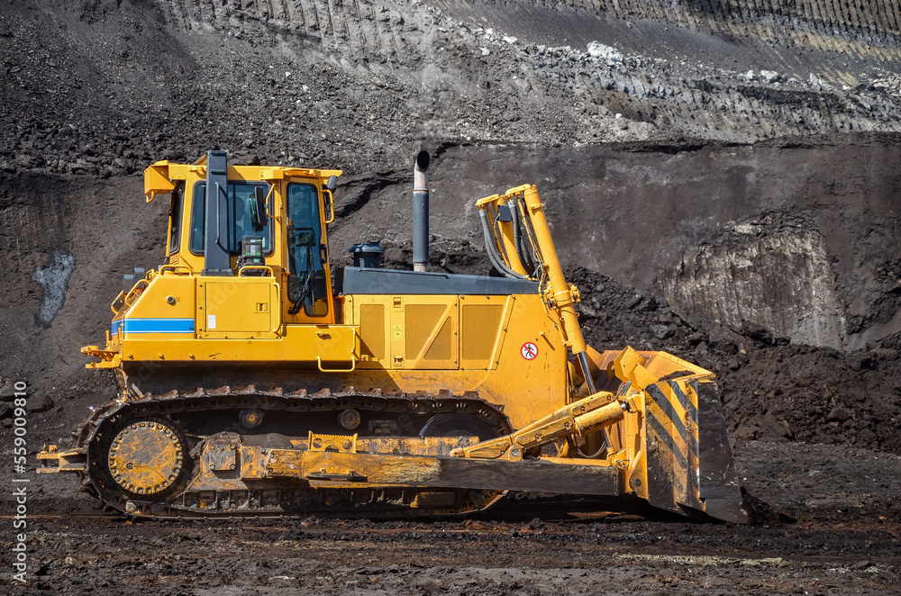 Crawler dozer working on construction site or quarry. Mining machinery ...