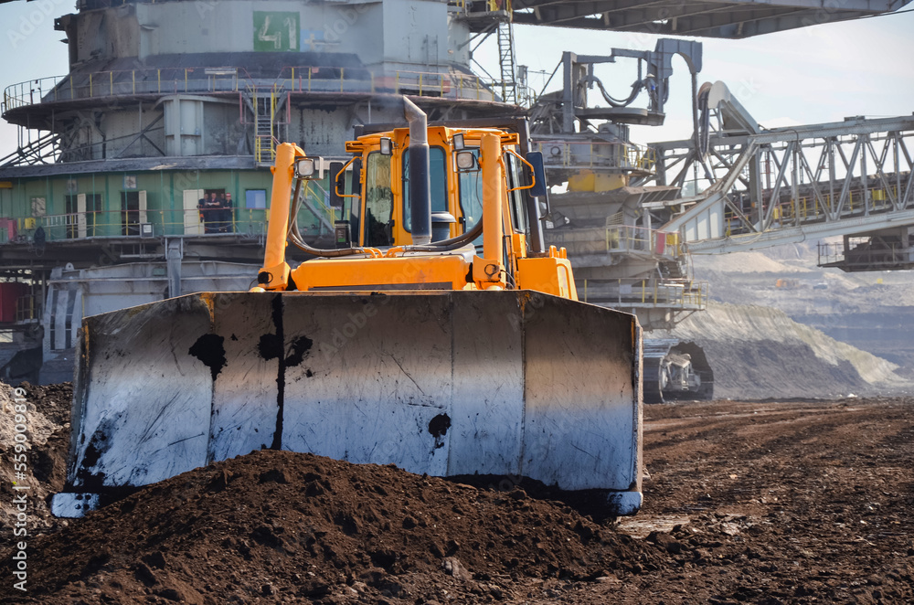 Crawler dozer working on construction site or quarry. Mining machinery ...