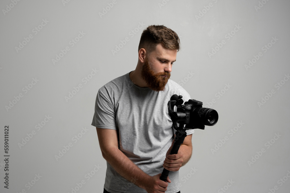 Side view of professional bearded videographer, cinematographer ...