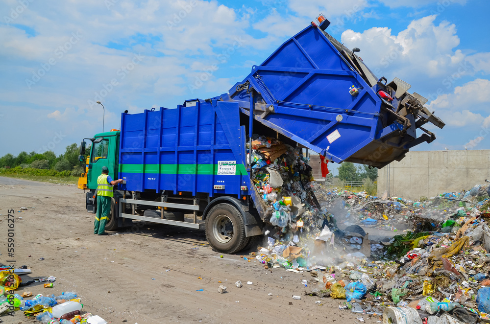 Garbage truck dumping the garbage on a landfill Stock Photo | Adobe Stock