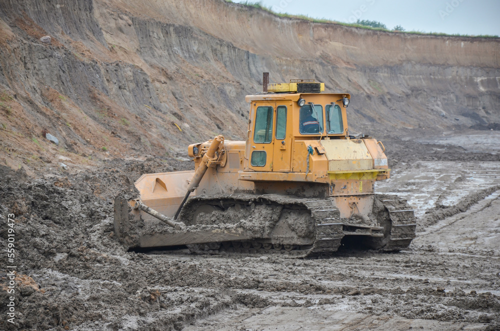 Crawler dozer working on construction site or quarry. Mining machinery ...