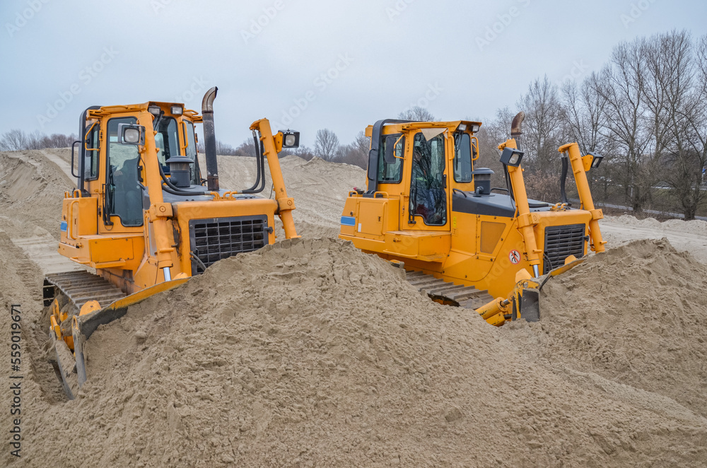 Crawler dozers working on construction site or quarry. Mining machinery ...