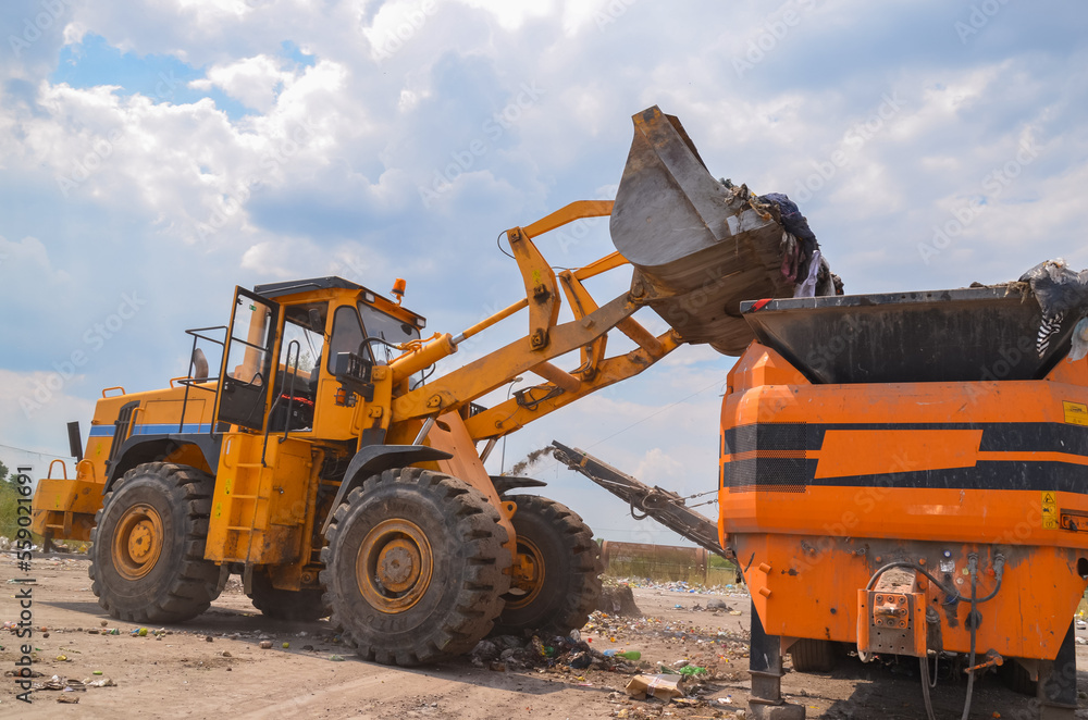 Wheel loader on landfill. Sorting rubbish by wheel loader Stock Photo ...