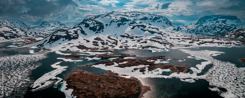Snowy landscape of Hardangervidda national park with mountains and icy ...