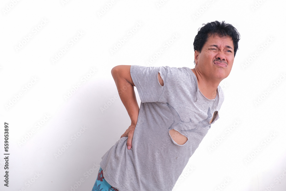 Poor man in very dirty clothes suffering from a bad backache Stock ...