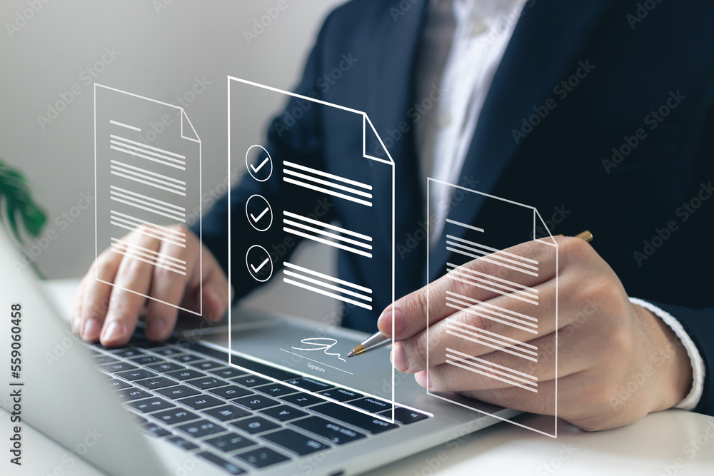 Businessman using a pen to sign electronic signature on documents file ...