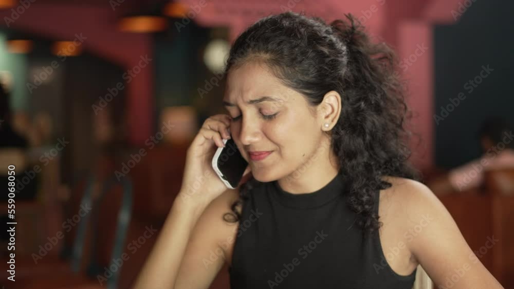 Close-up Indian business woman talking on phone isolated on cafe ...
