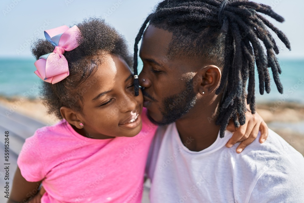 Father and daughter smiling confident hugging each other and kissing at seaside Stock Photo ...
