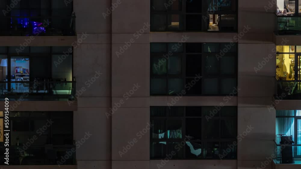 Windows of apartment building at night timelapse, the light from ...