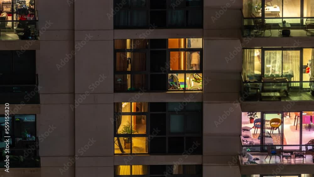 Windows of apartment building at night timelapse, the light from ...