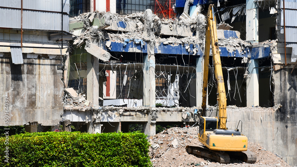 Building demolition, Backhoe excavator and truck clearing wreckage ...