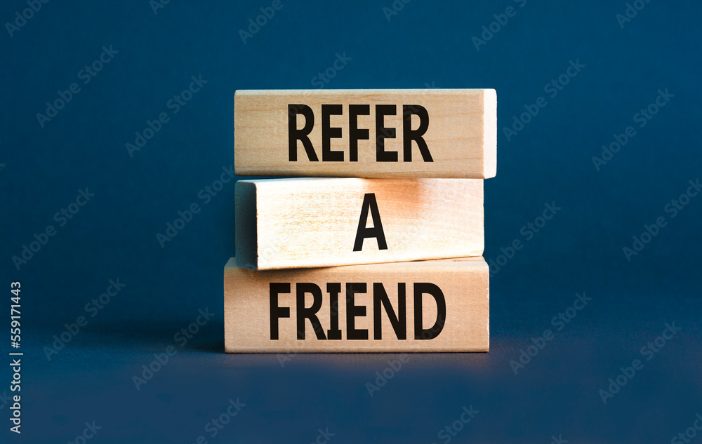Refer a friend symbol. Concept words Refer a friend on wooden blocks on ...