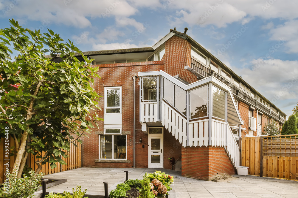 an outside view of a house with brick walls and white trim on the side ...