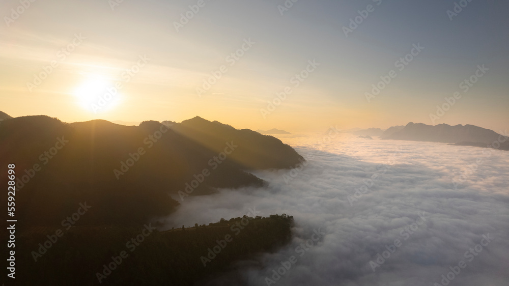 Amazing sun rise over mountain against white sea of clouds or mist over ...
