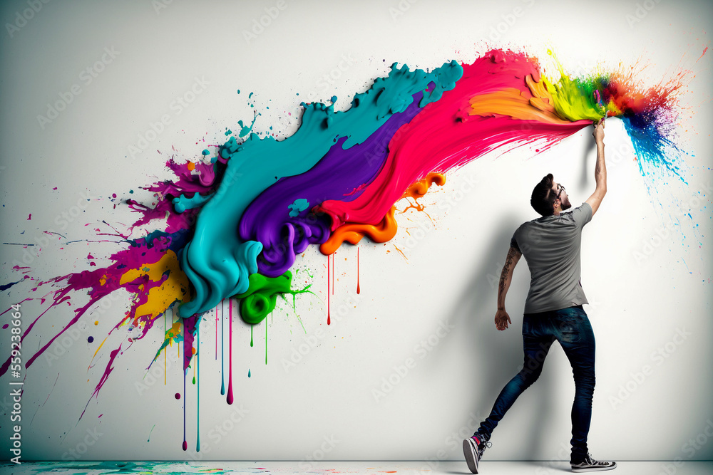 Lustiger Maler streicht eine weiße Wand bunt mit color splash Stock ...