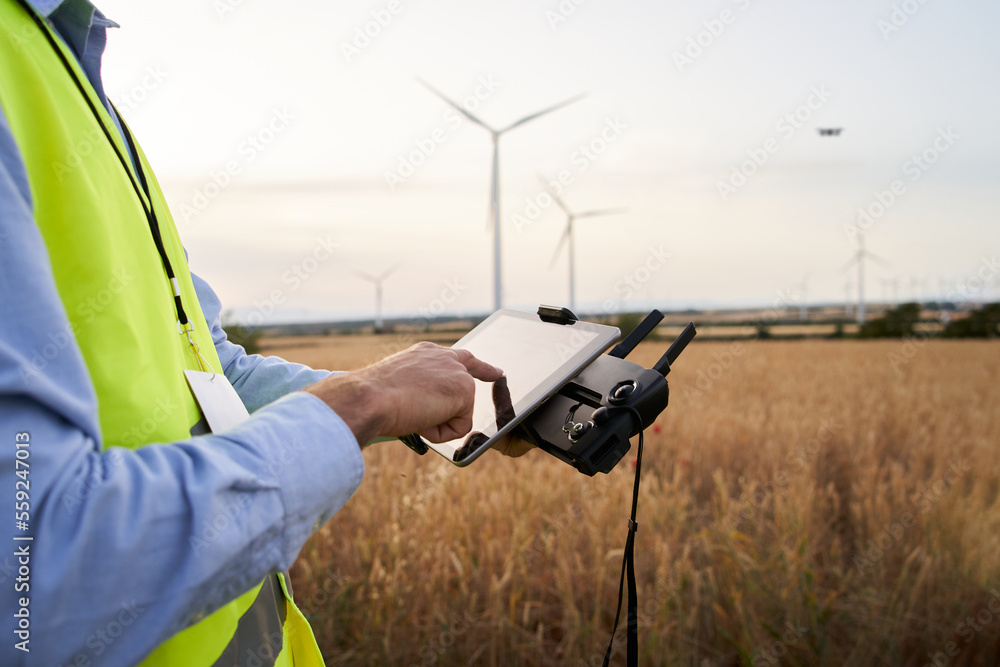 Operator holding remote control and quadcopter. Unmanned aerial copter ...
