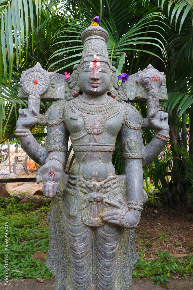 Religious sculpture in Tirumala. Venkateswara Balaji in front of palm ...