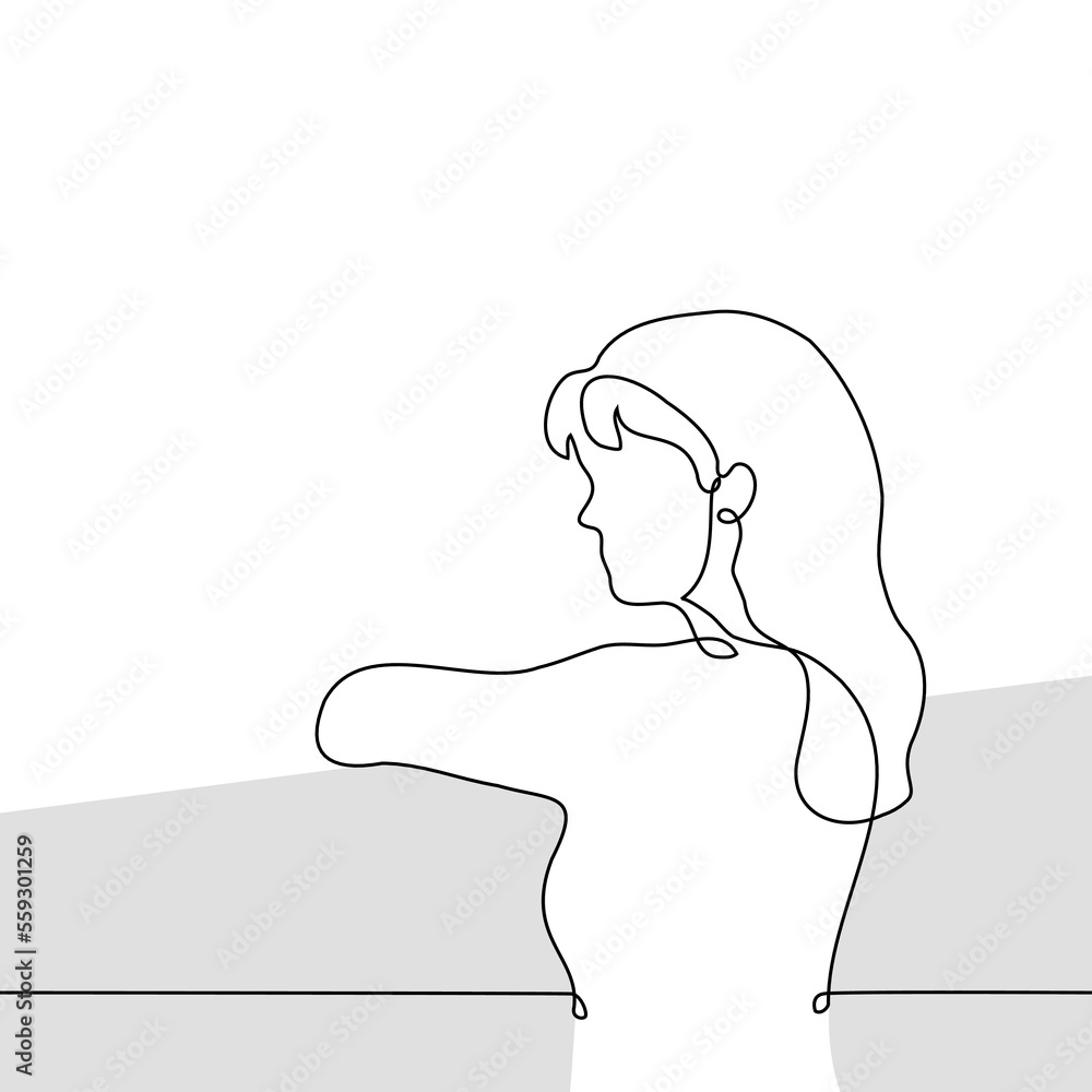 woman stands with her hands on the high railing and looks into the ...