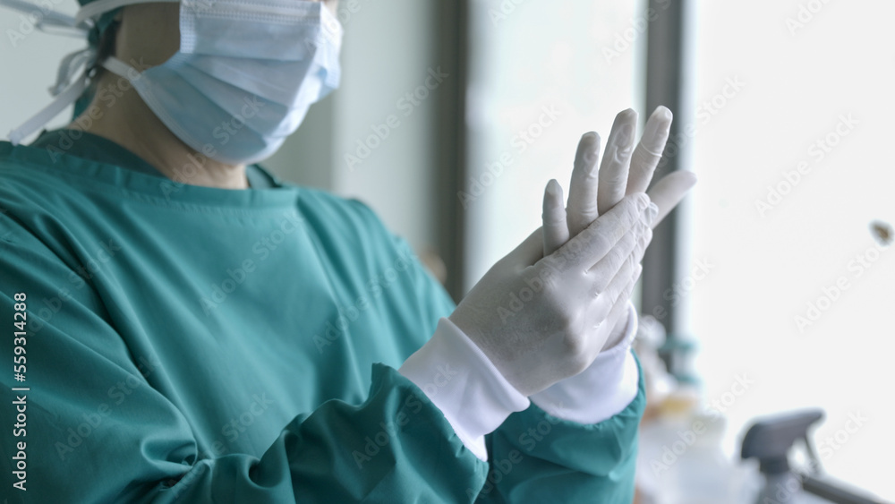 Doctor putting on surgical gloves , professional medical safety and ...