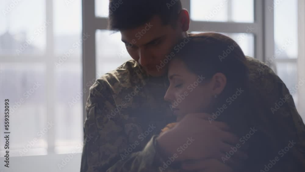Sad military man hugging beloved woman before leaving for war in hot ...