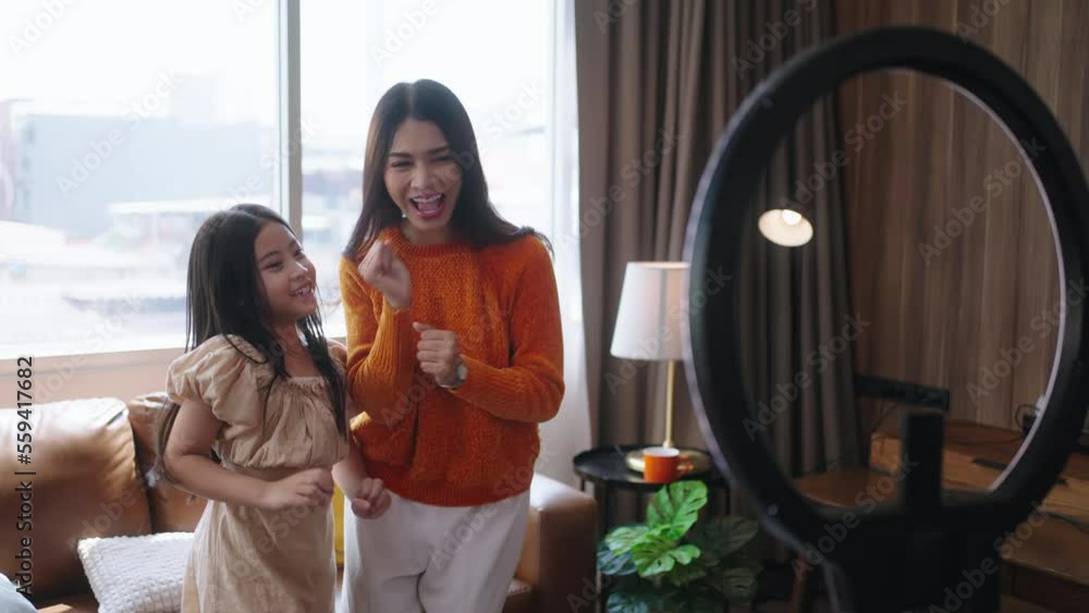young asia mother enjoying playtime with funny crazy asian child ...