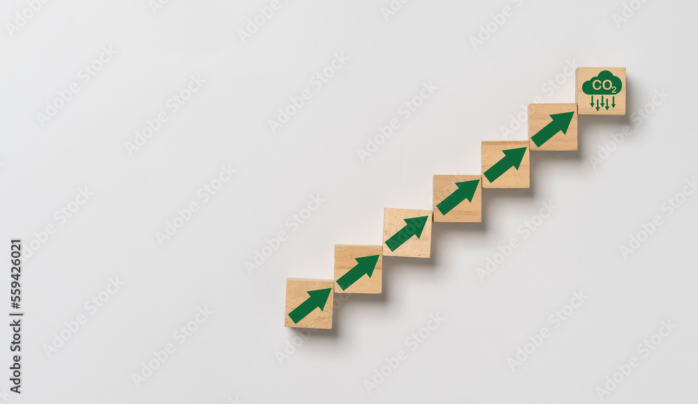 CO2 reducing icon with up arrow on wooden block cube for enhance ...