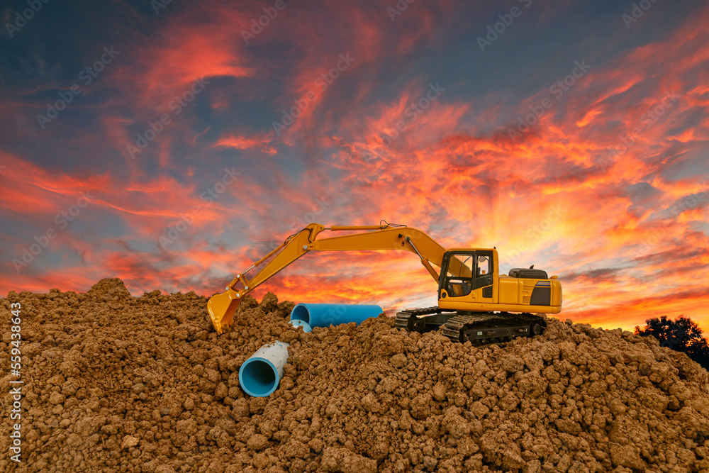 crawler excavators digging water pipes at construction site on sky ...