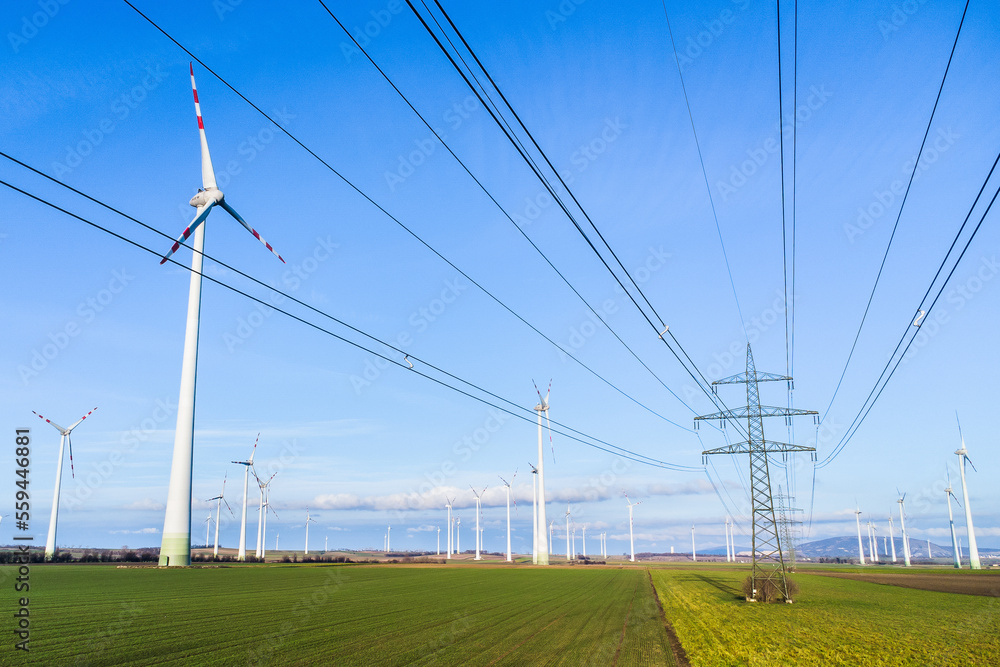Cables and wires of an electrical power line with windmills for wind ...