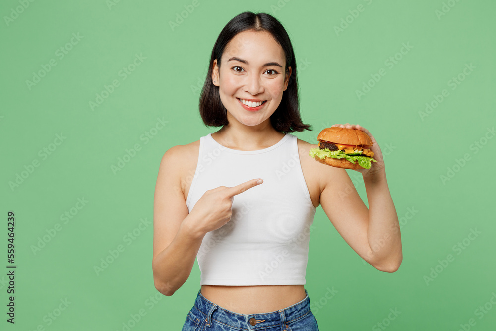 Young smiling happy fun woman wear white clothes hold show eat point ...