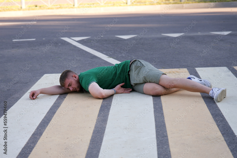 Young unconscious dead man at accident scene, crash on road, crosswalk ... Young unconscious dead man at accident scene, crash on road, crosswalk ...