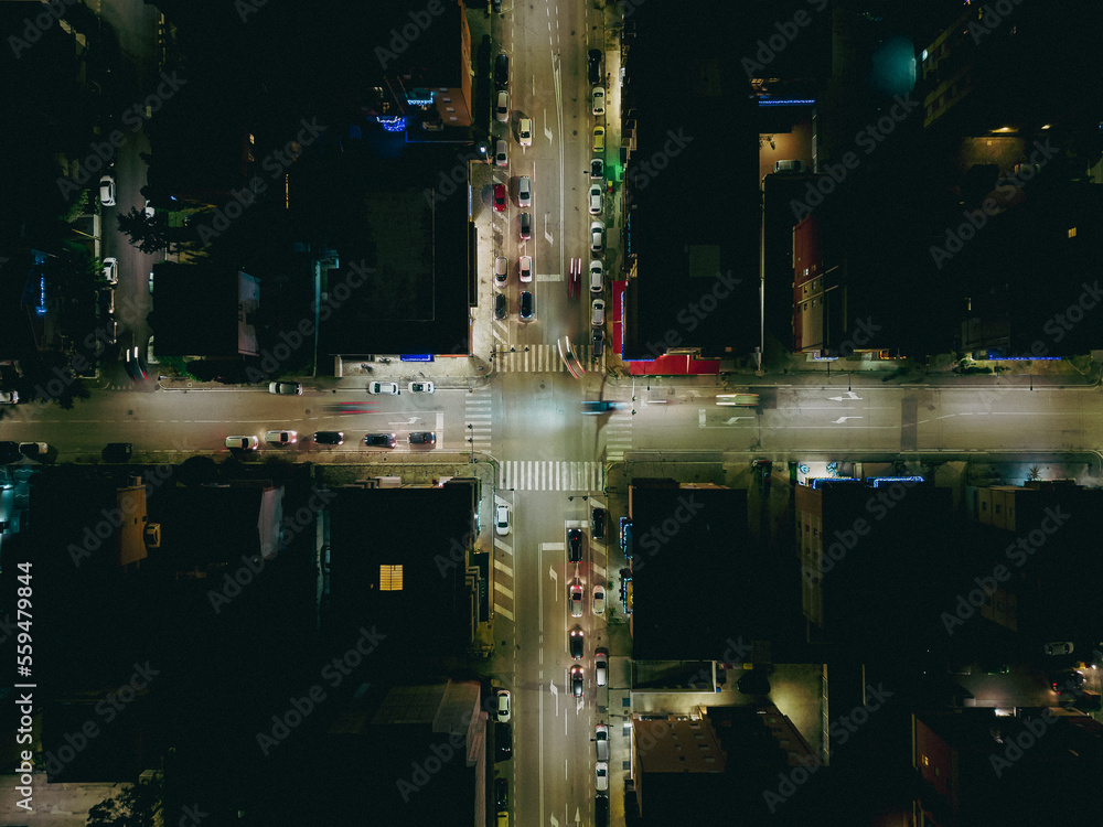 Poster night aerial view of a city intersection busy with cars and ...