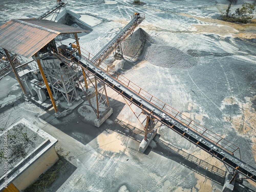 Stone crushing system at open pit mining quarry. Stones are carried ...