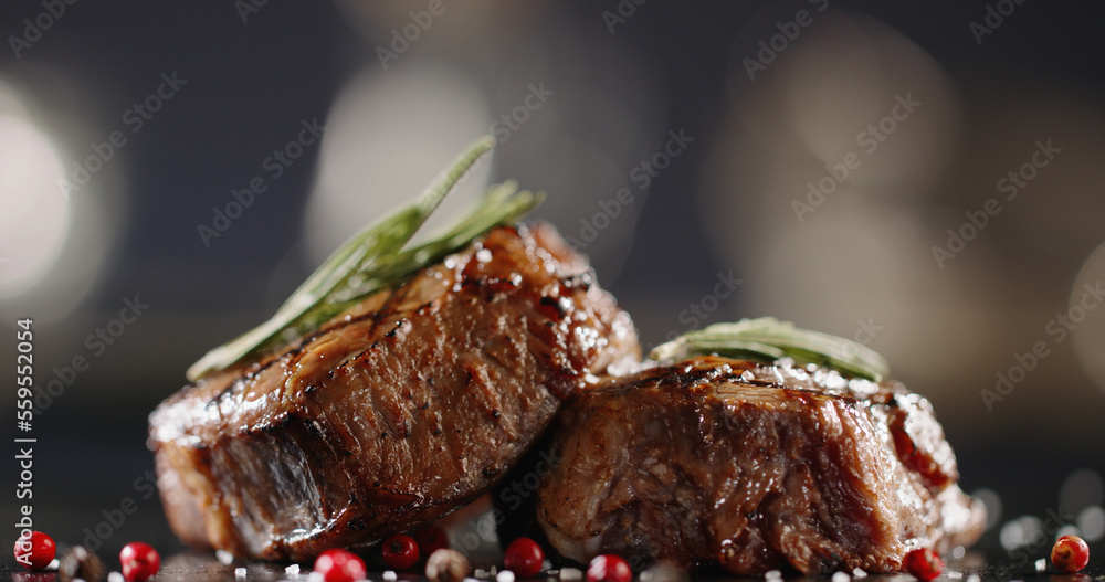 Beautiful peaces of grilled meat decorated on plate with rosemary and ...