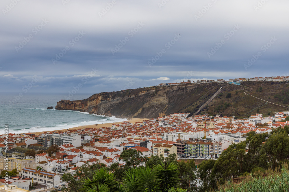 Wide view of the city of Nazaré, the beach, cliffs, funicular and the ...