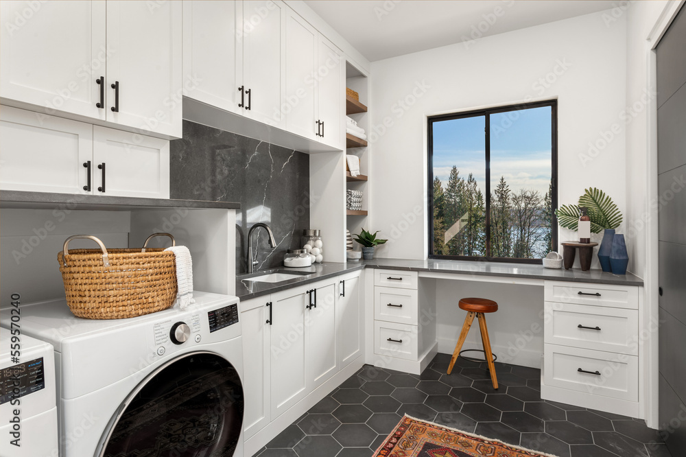 Laundry Room In New Custom Built Luxury Home Features Sink Desk And
