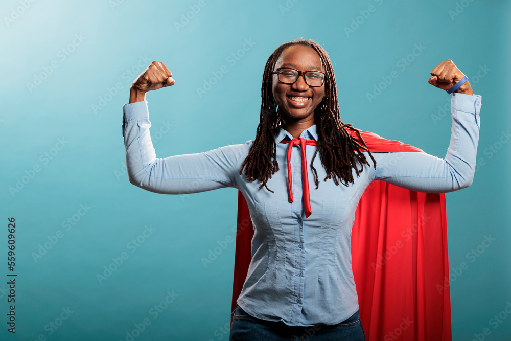 Proud and tough looking young adult superhero woman showing ...