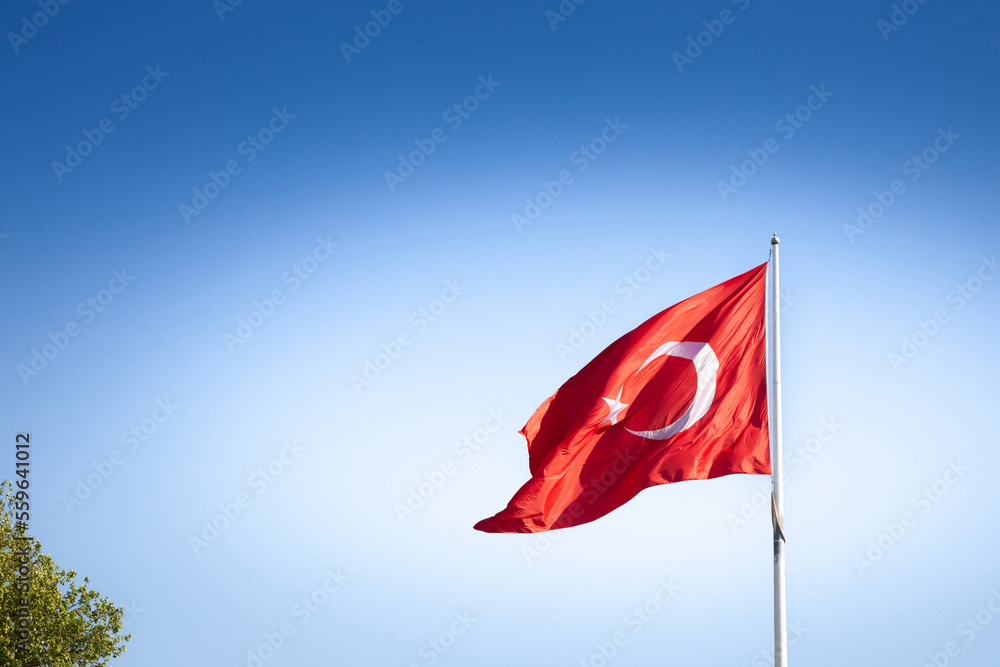 Turkish flag floating in the air in front of a blue sky in istanbul ...