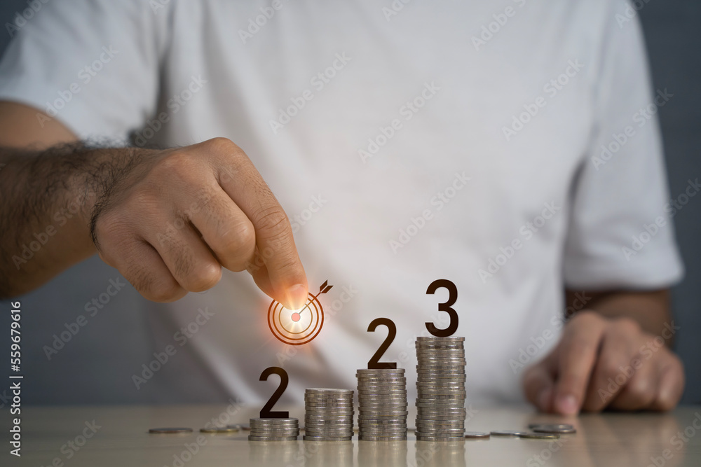 Foto de Hand business man target dart goal 2023 on top rows stack of ... Foto de Hand business man target dart goal 2023 on top rows stack of ...