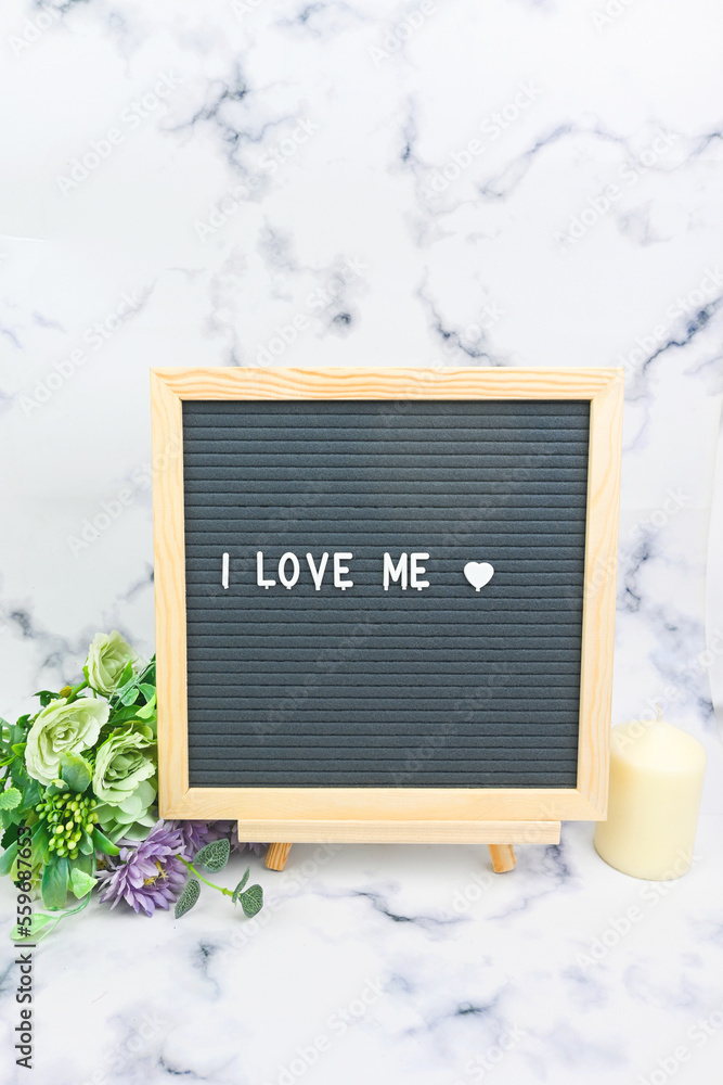 Letter board with phrase I love me white background, flowers with heart ...