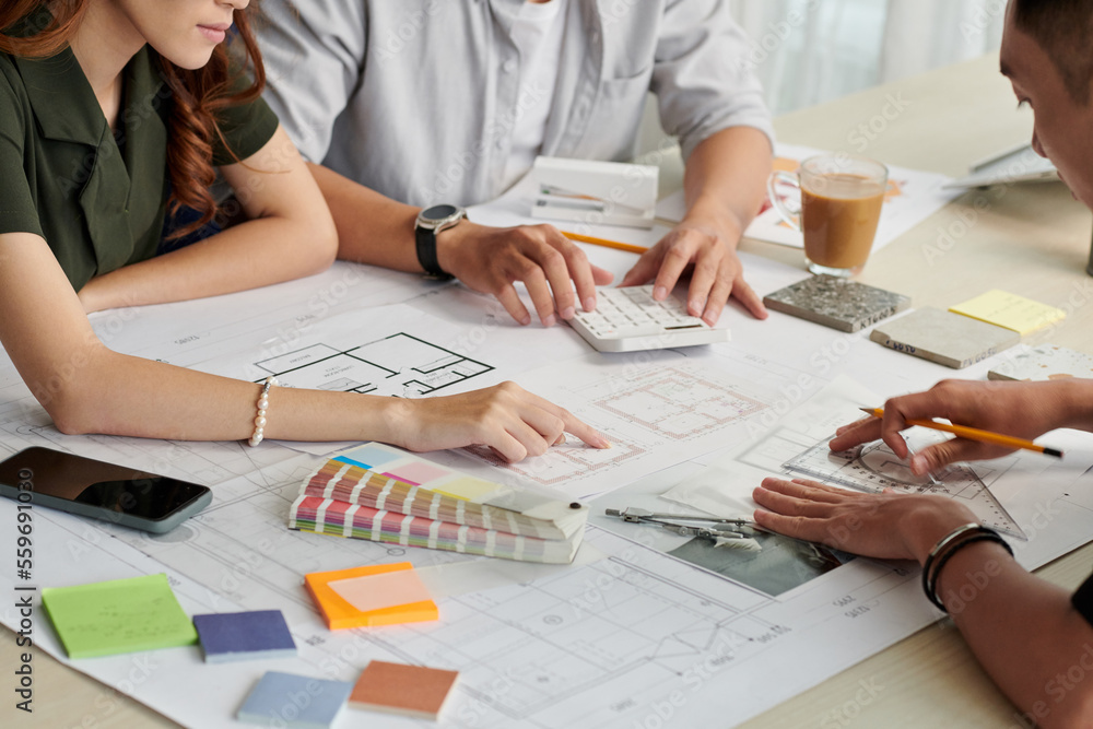 Group of architects gathered at big office table to discuss ideas for ...