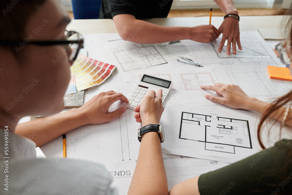 Architects and interior designers measuring rooms dimensions on house ...